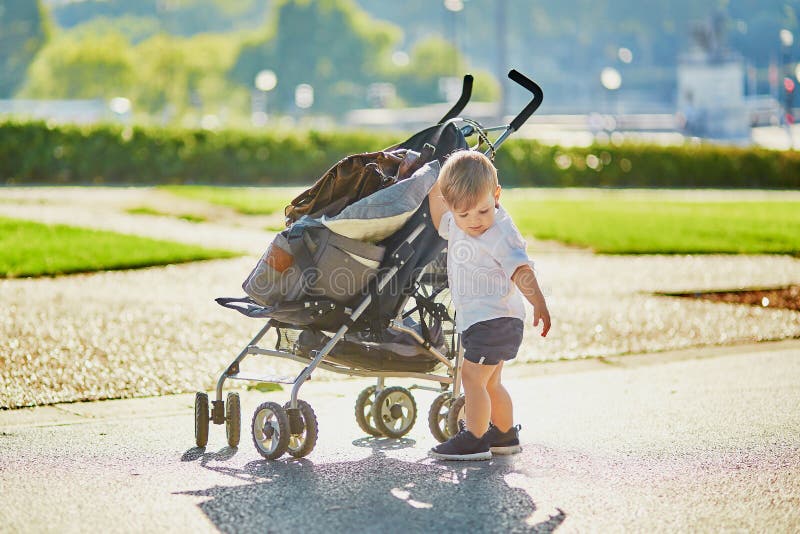 Cute Little Boy Pushing His Stroller Stock Photo - Image of human ...