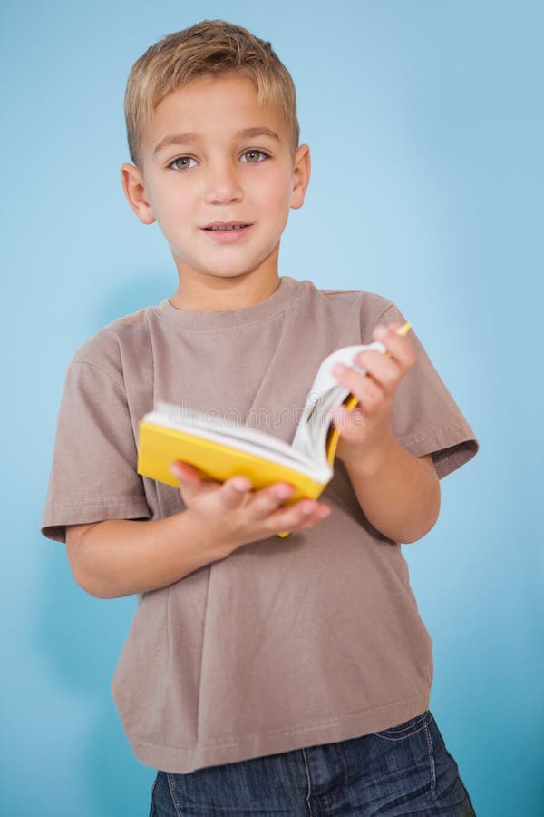 Cute Little Boy Reading in Classroom Stock Photo - Image of camera ...