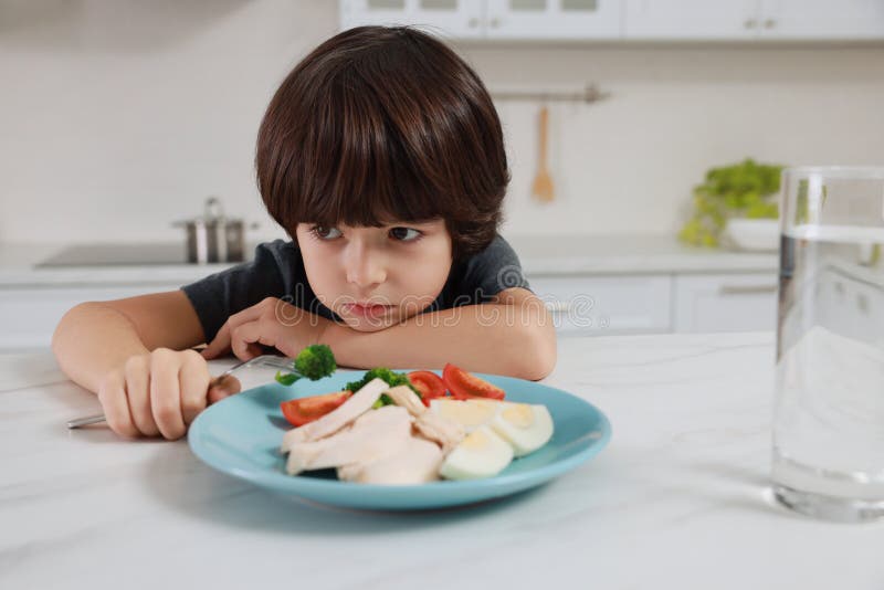 Cute Little Boy Refusing To Eat Dinner in Kitchen Stock Image - Image ...
