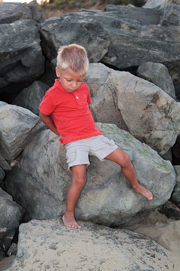 Cute Little Boy on the Rocks Stock Photo - Image of horizontal ...
