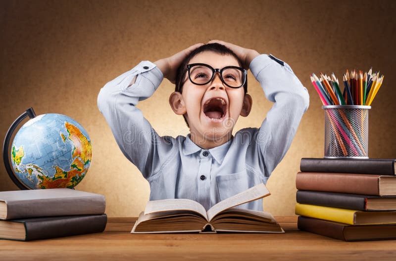 Cute Little Boy Schoolboy Doing Homework at a Table with Books Stock ...