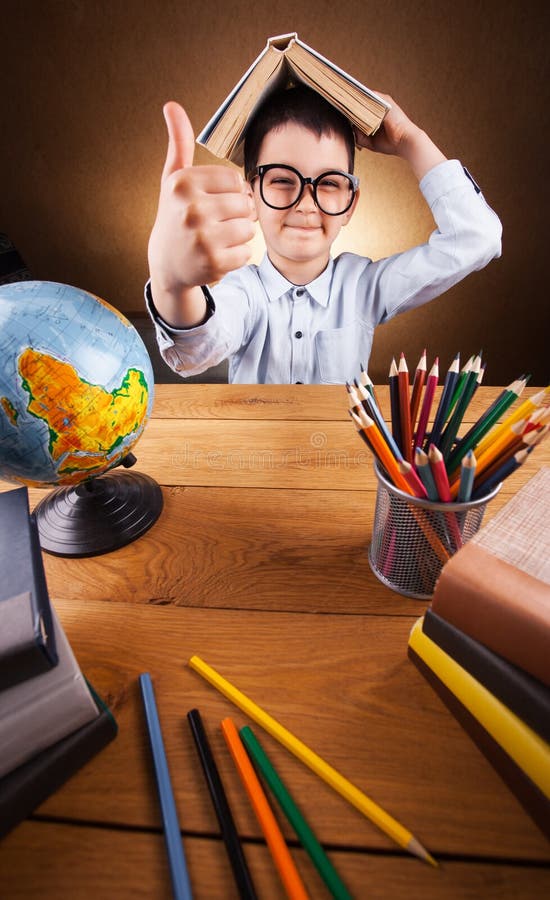 Cute Little Boy Schoolboy Doing Homework at a Table with Books Stock ...