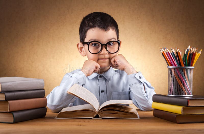 Cute Little Boy Schoolboy Doing Homework at a Table with Books Stock ...