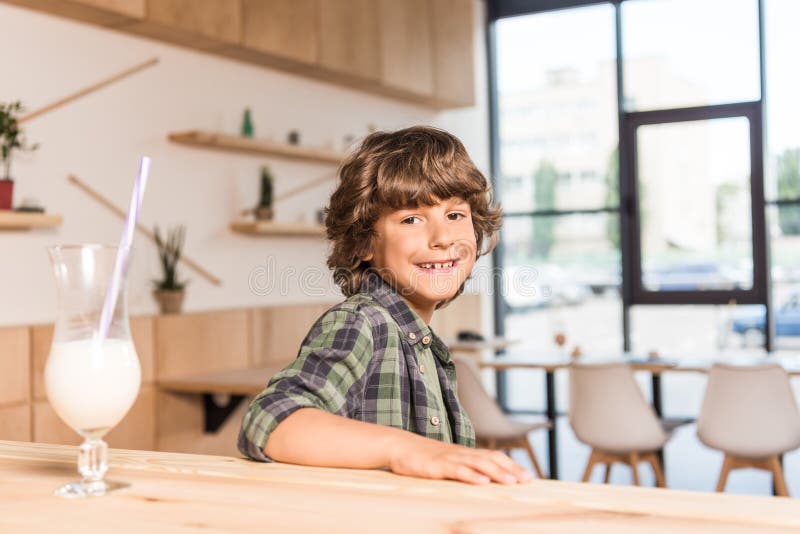 Cute Little Boy Sitting in Cafe with Milkshake Stock Image - Image of ...