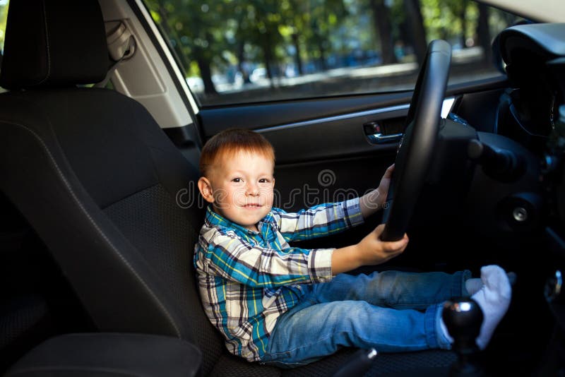 Cute Little Boy Smiling and Driving Fathers Car Stock Photo - Image of ...