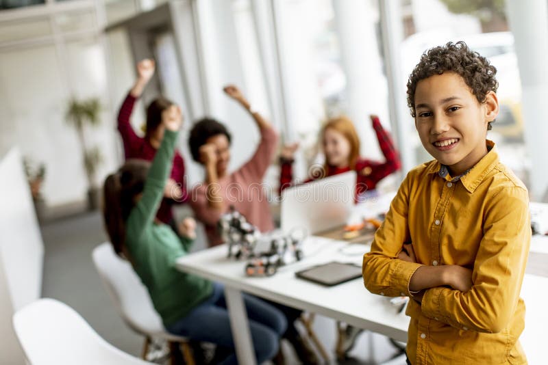 Cute Little Boy Standing in Front of Kids Programming Electric Toys and ...