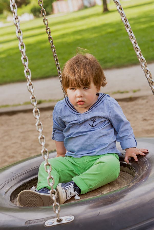 Cute little boy on a swing stock image. Image of male - 62214611