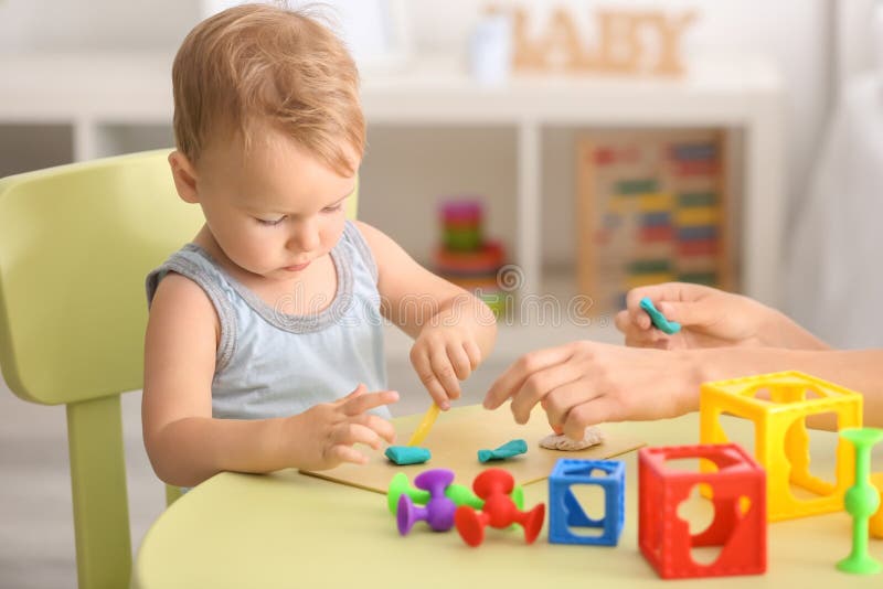 Cute Little Boy Using Play Dough at Table Indoors Stock Photo - Image ...
