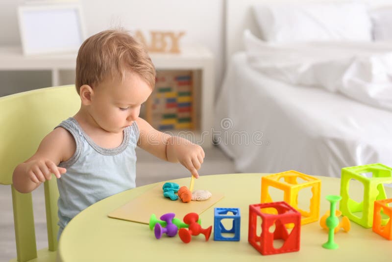 Cute Little Boy Using Play Dough at Table Indoors Stock Photo - Image ...