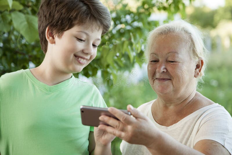 Cute Little Boy Using Smartphone with Grandma at Home Veranda Stock ...