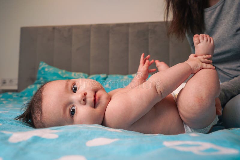 A Cute Little Boy Wearing a Diaper is Looking at the Camera. Side View ...