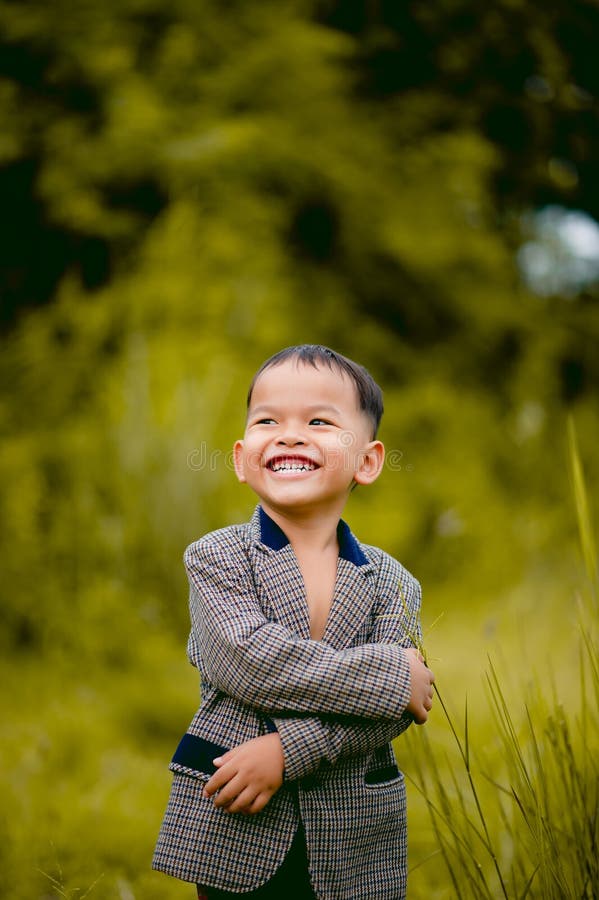 Little Boy a Well-dressed Boy in a Suit in a Backyard with a Lawn and ...