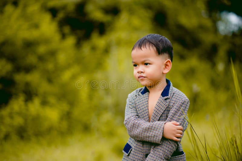 Little Boy a Well-dressed Boy in a Suit in a Backyard with a Lawn and ...