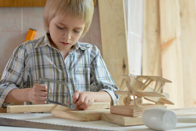 Portrait of Cute Little Boy Working with Wood in Workshop Stock Photo ...