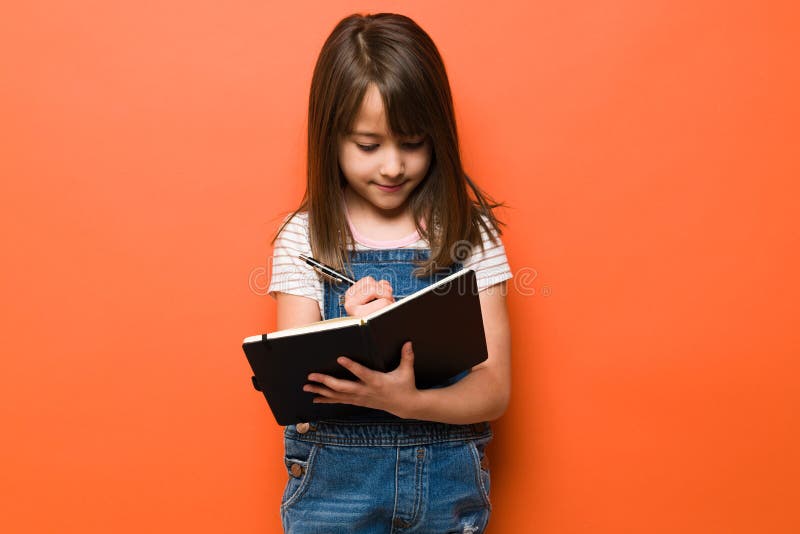 Pretty Little Girl Writing on a Diary Stock Photo - Image of school ...