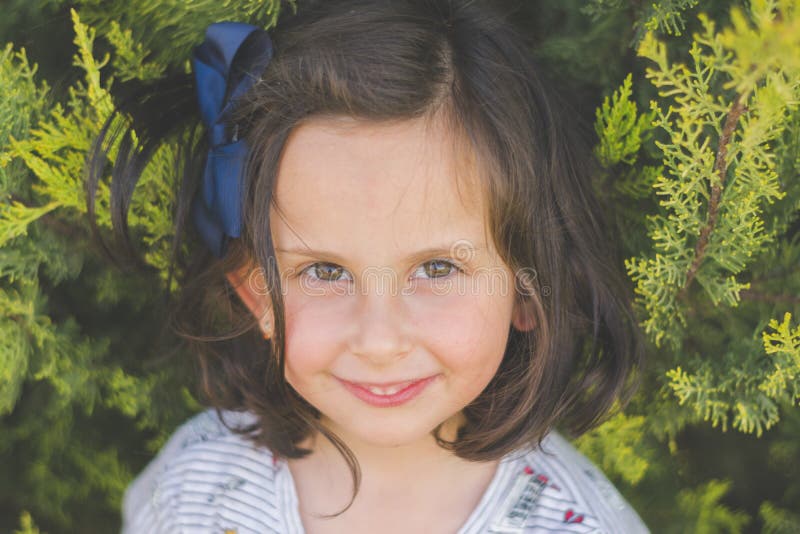 Cute Little Child with a Beautiful Smile Standing by a Pine Tree Stock ...