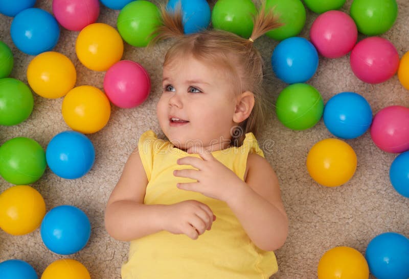 Cute Little Child Playing with Balls on Floor Stock Image - Image of ...