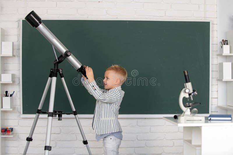 Cute Little Child with Telescope in Classroom at Elementary School ...
