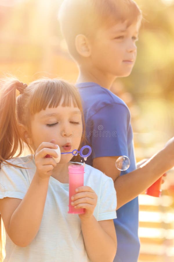 Cute Little Children Blowing Soap Bubbles Outdoors Stock Photo - Image ...