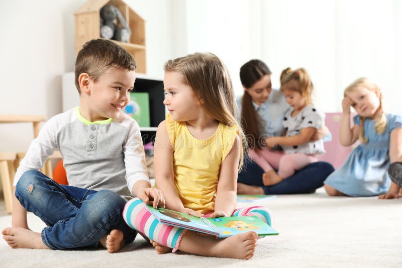 Cute Little Children Reading Book Together Indoors. Learning and ...