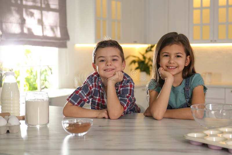 Cute Children at Table with Cooking Ingredients in Kitchen Stock Photo ...