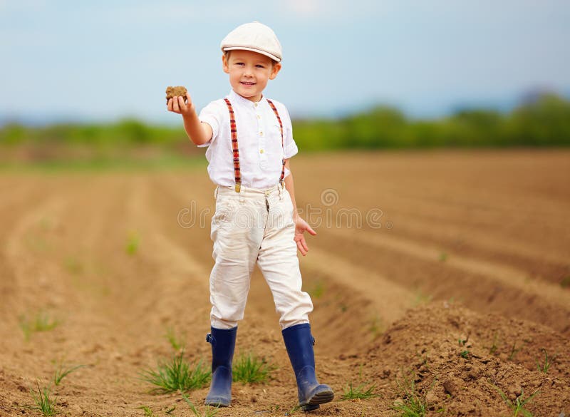 Cute Little Farmer on Spring Field Holding Earth Clod Stock Image ...
