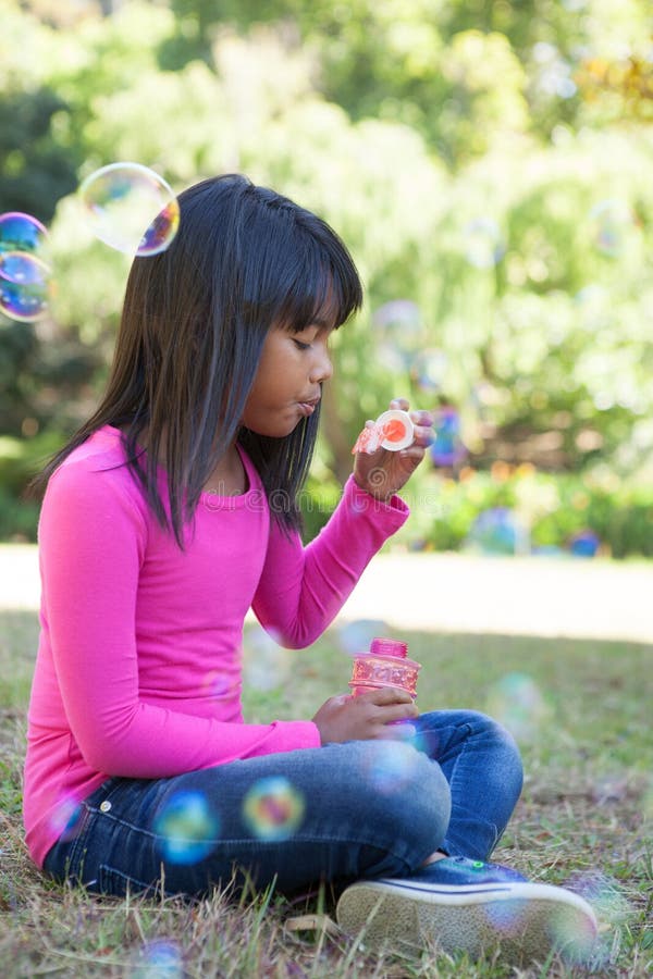 Cute Little Girl Blowing Bubbles Stock Image - Image of lawn ...
