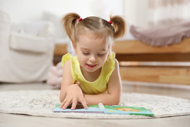 Cute little girl with book stock photo. Image of color - 171351790