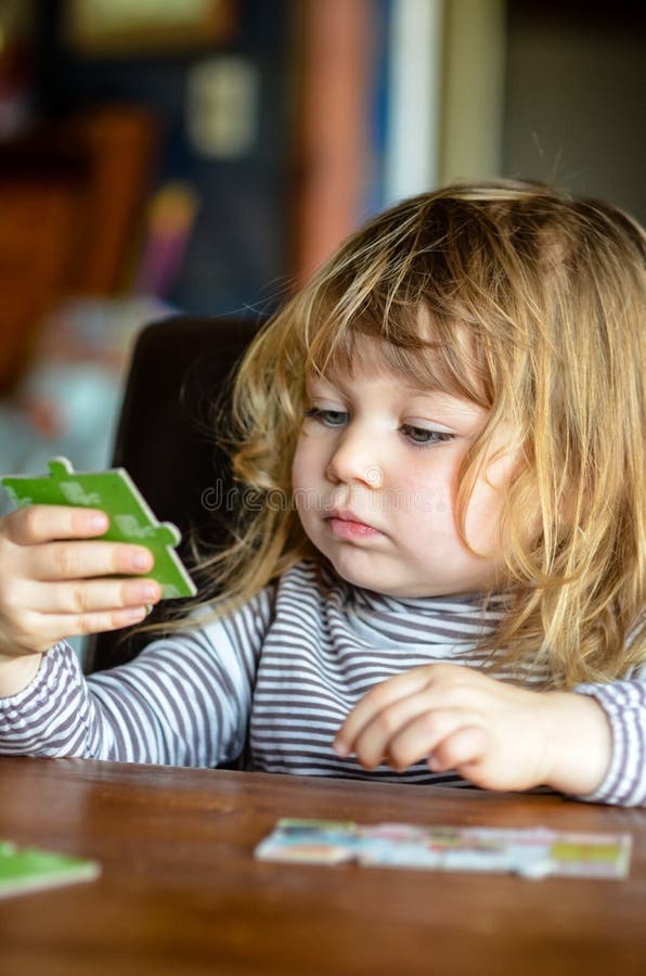 Portrait of a Cute Little Girl Doing a Puzzle Stock Image - Image of ...