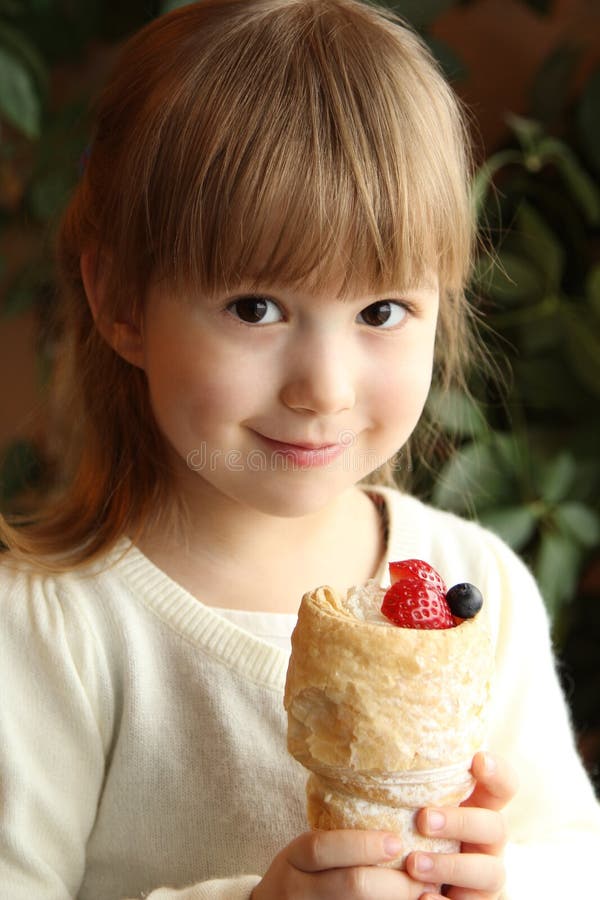 Cute Little Girl is Eating Cake Stock Photo - Image of happiness ...