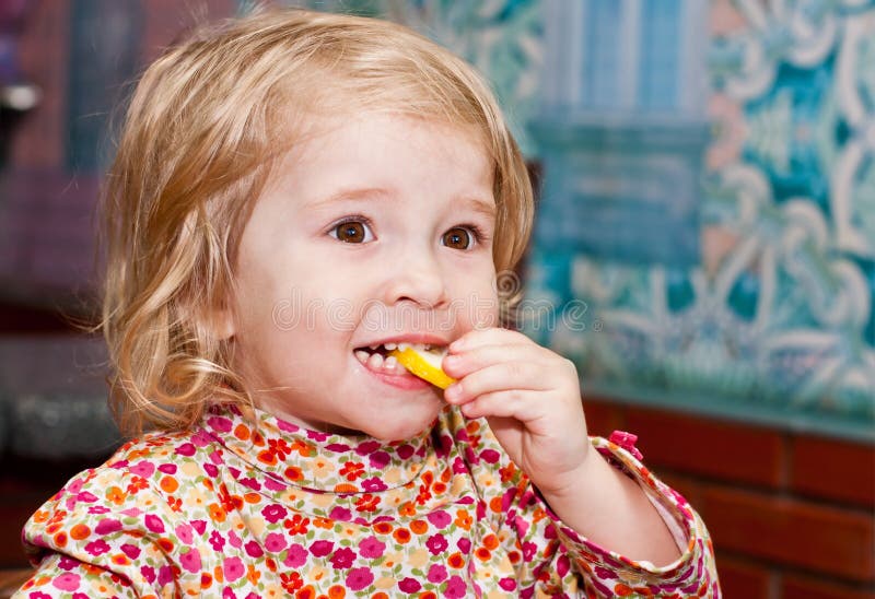 Cute Little Girl Eats a Lemon Stock Image - Image of lemon, cute: 33445353