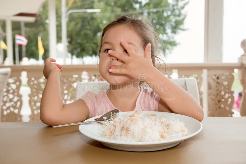 Cute Little Girl Eats Rice in a Summer Cafe Stock Photo - Image of food ...