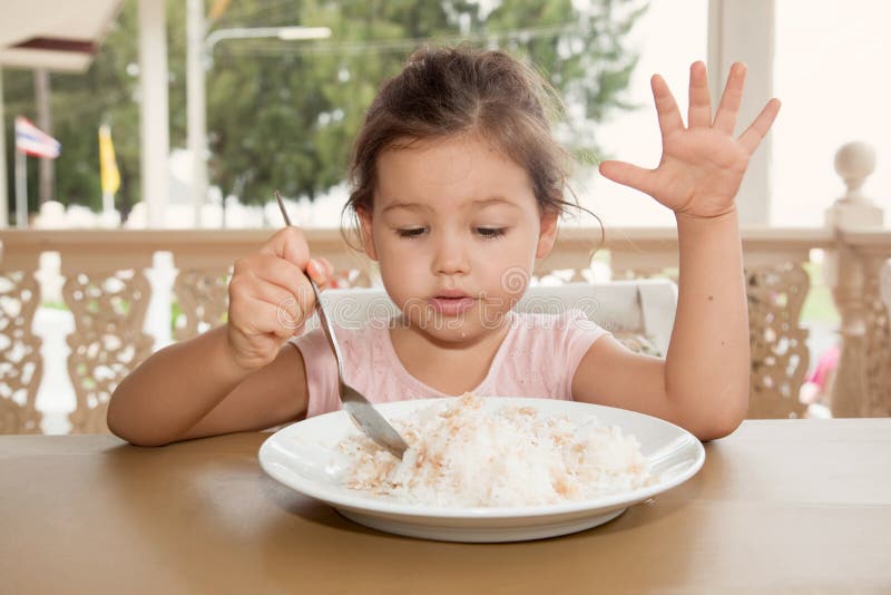 Cute Little Girl Eats Rice in a Summer Cafe Stock Image - Image of ...