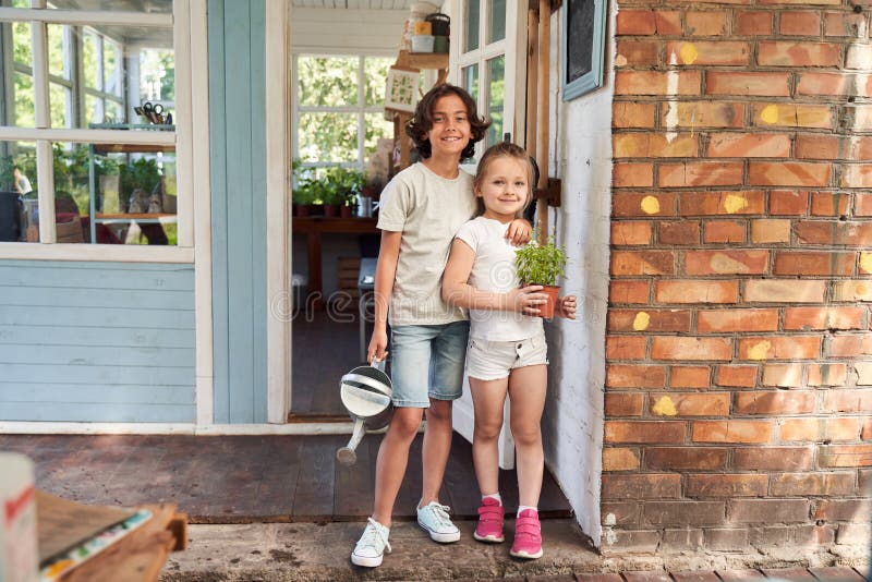 Adorable Siblings Standing on Porch of Their House Stock Photo - Image ... Adorable Siblings Standing on Porch of Their House Stock Photo - Image ...