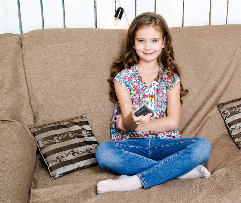 Cute Little Girl Holding a Remote Control Stock Photo - Image of ...
