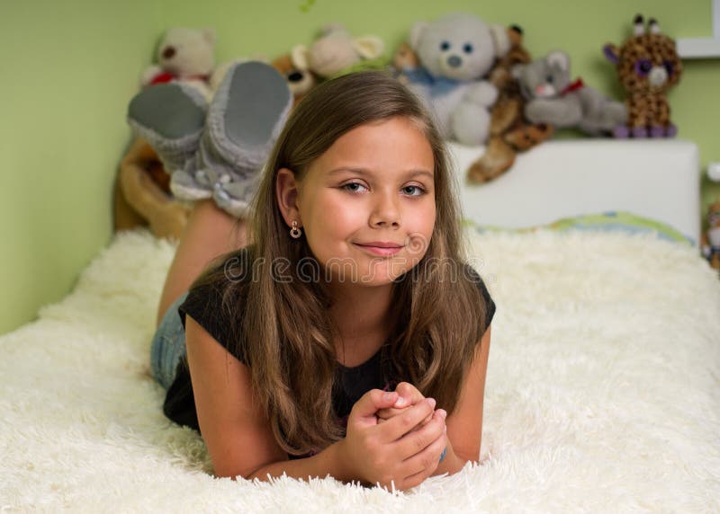 Cute Little Girl Laying on the Bed Stock Photo - Image of beautiful ...