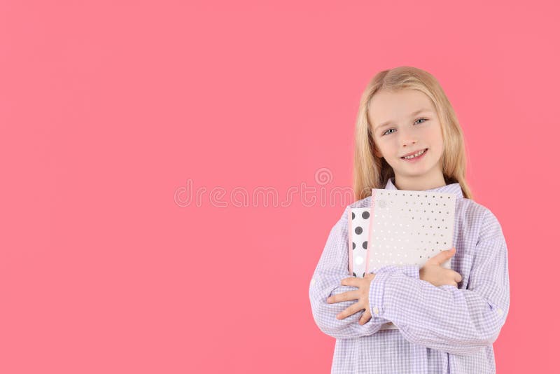 Cute Little Girl with Notebooks on Pink Background Stock Photo - Image ...