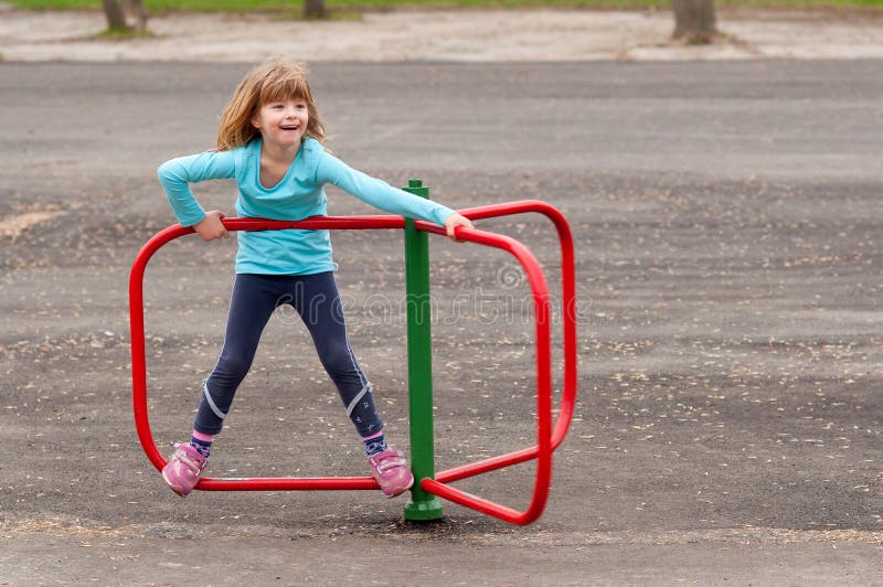 Cute Little Girl Playing on Merry Go Round Stock Photo - Image of ...