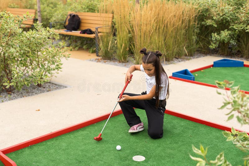 Cute Little Girl Playing Mini Golf in a Park. Stock Photo - Image of ...