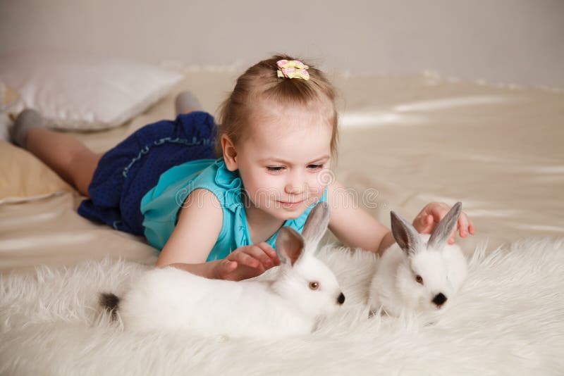 Cute Little Girl Playing with White Rabbits Stock Photo - Image of ...