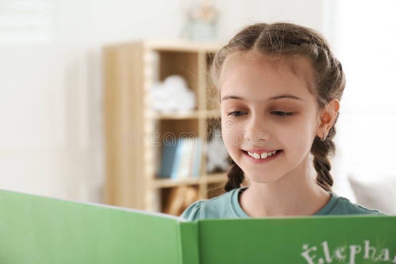 Cute Girl Reading Book at Home Stock Photo - Image of enjoy, indoors ...