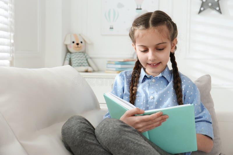 Cute Girl Reading Book on Sofa at Home Stock Image - Image of homework ...
