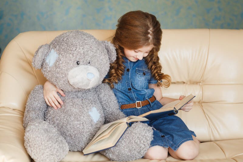 Cute Little Girl Reading with Teddy Bear Stock Photo - Image of hugging ...
