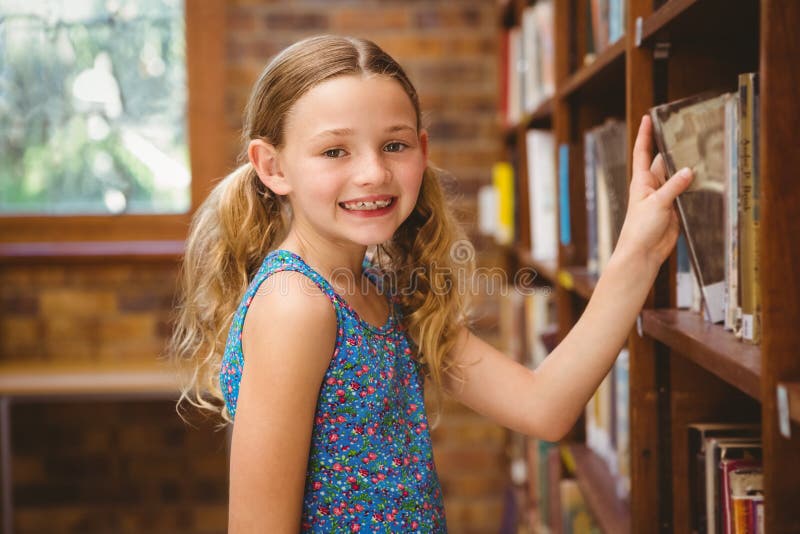 Cute Little Girl Selecting Book in Library Stock Photo - Image of ...