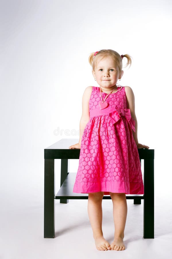 Cute Little Girl Sitting on Table Stock Photo - Image of preschooler ...