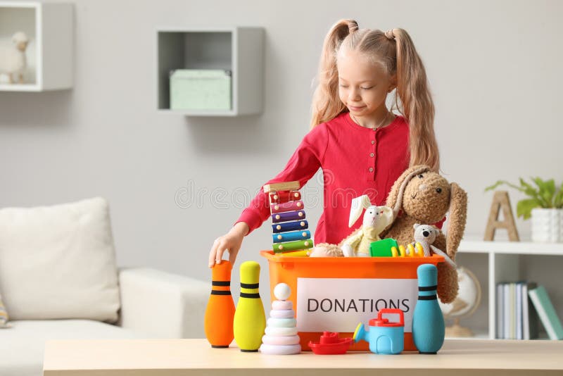 Cute Little Girl Sorting Donation Box at Home Stock Photo - Image of ...