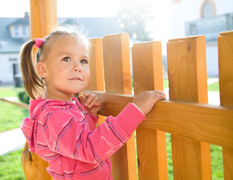Cute Little Girl is Standing Near a Fence Stock Image - Image of cute ... Cute Little Girl is Standing Near a Fence Stock Image - Image of cute ...