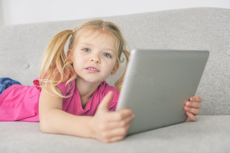 Cute Little Girl with Tablet Using Home Stock Image - Image of ...