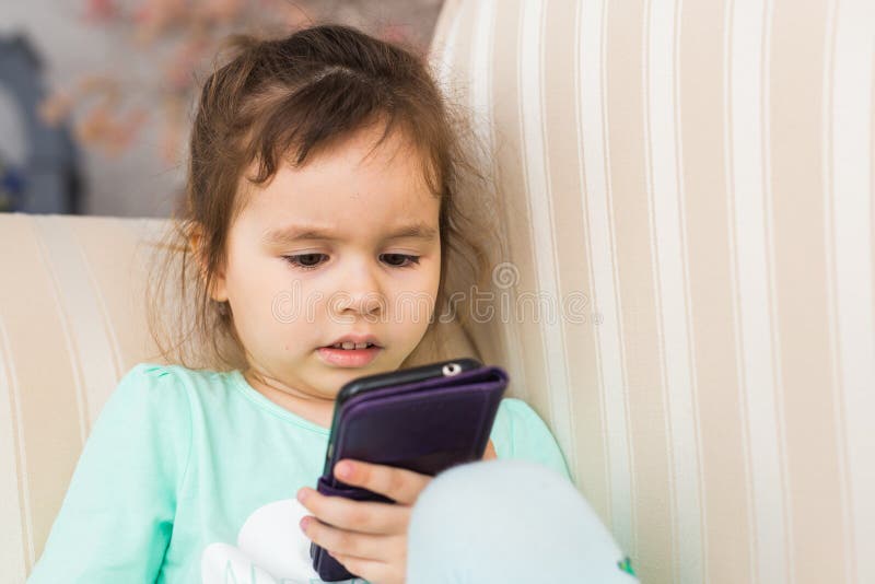 Cute Little Girl Using Modern Smartphone Stock Photo - Image of ...
