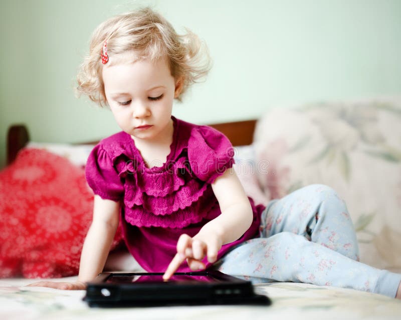 Happy Little Girl Lying on Bed with Tablet Computer Stock Image - Image ...